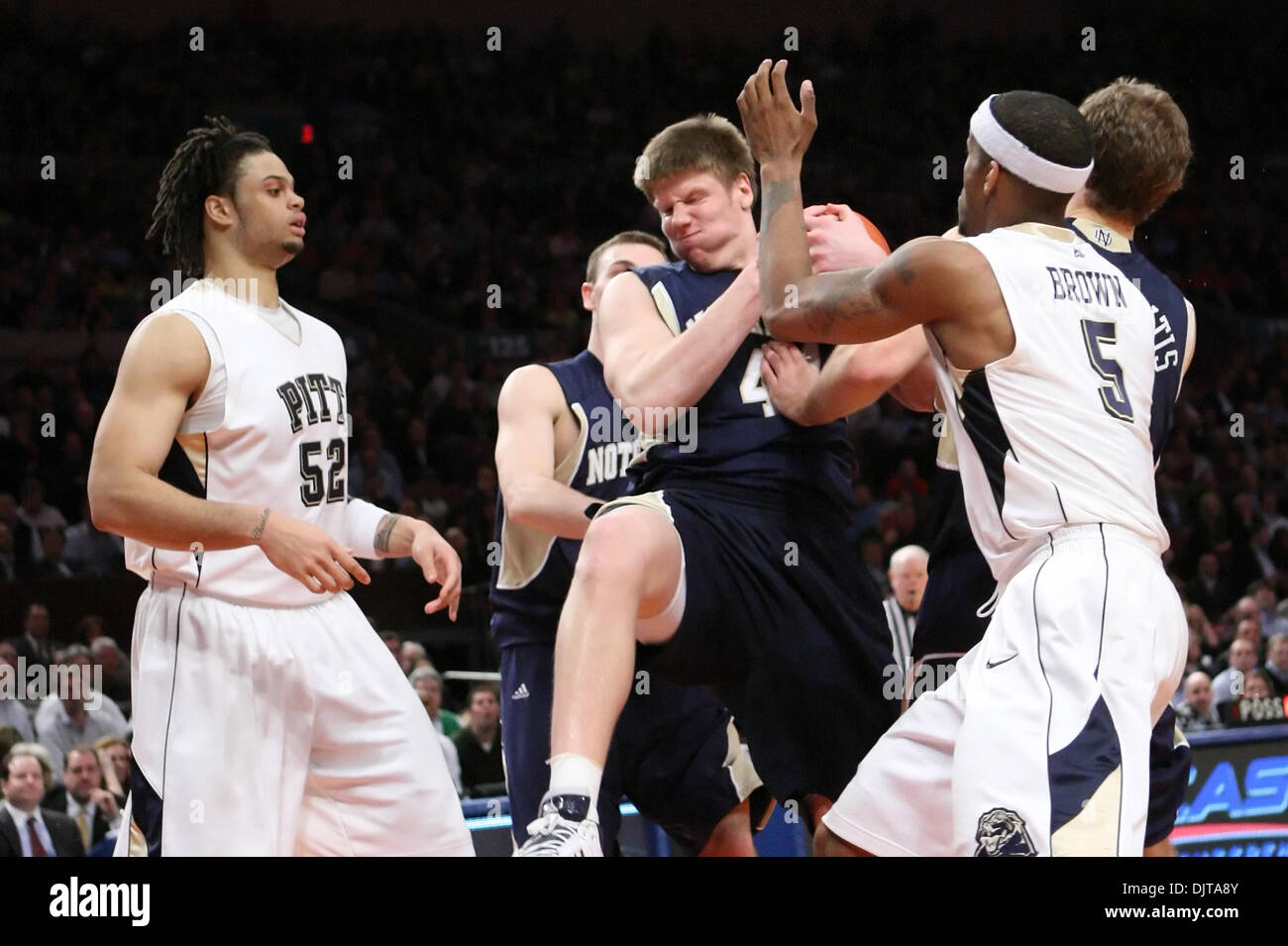 Notre Dame forward Luke Harangody #44 comws down with the rebound ...