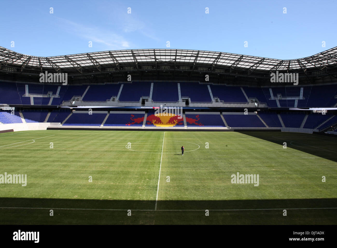 A lone Red Bull player walks the field. Media Day at Red Bull Arena ...