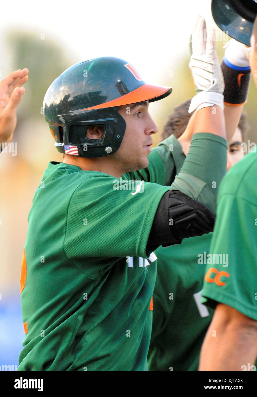 Miami Hurricanes first baseman Scott Lawson receives congratulations ...