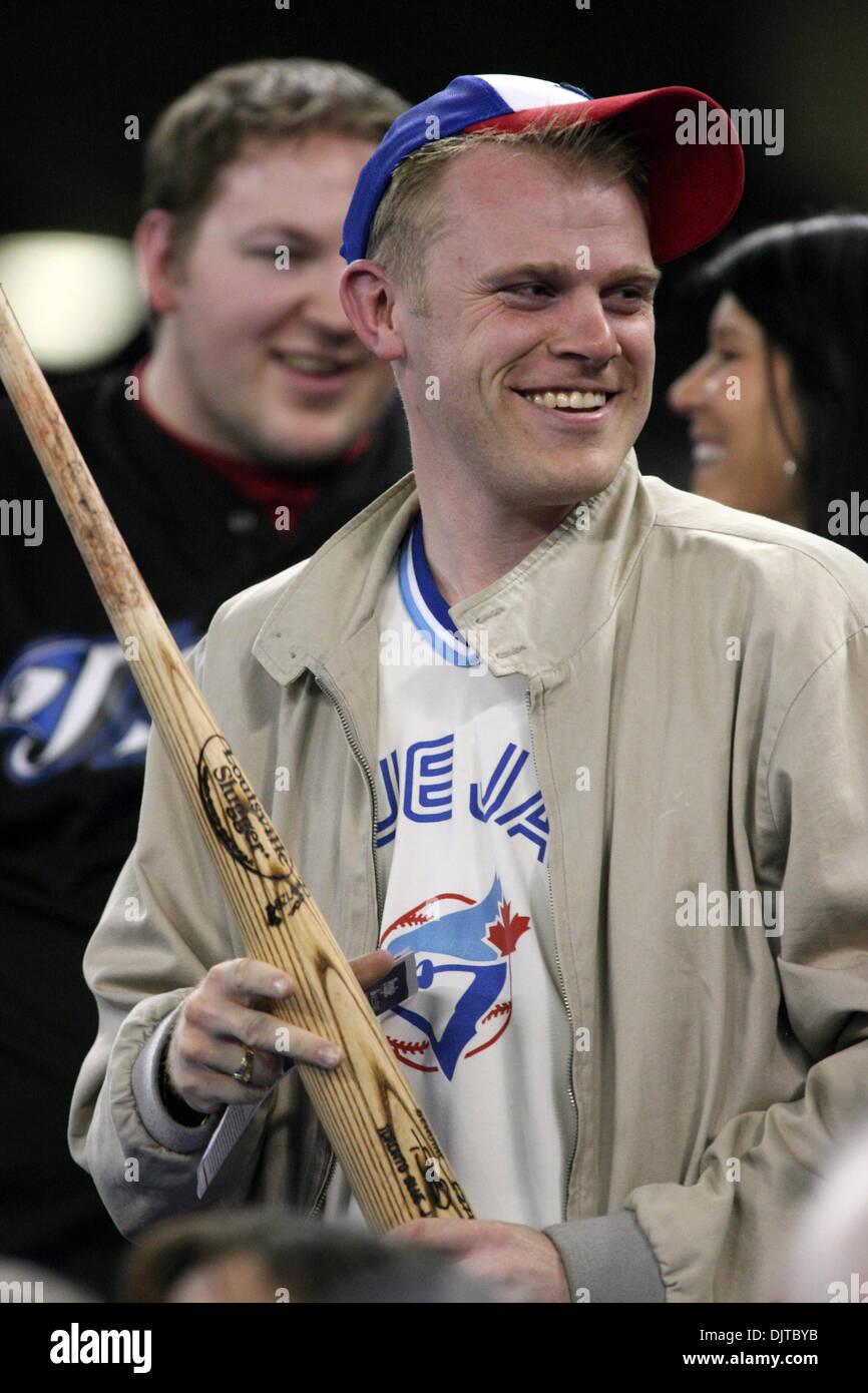 A Toronto Blue Jays fan holds a bat that he caught after Toronto Blue ...