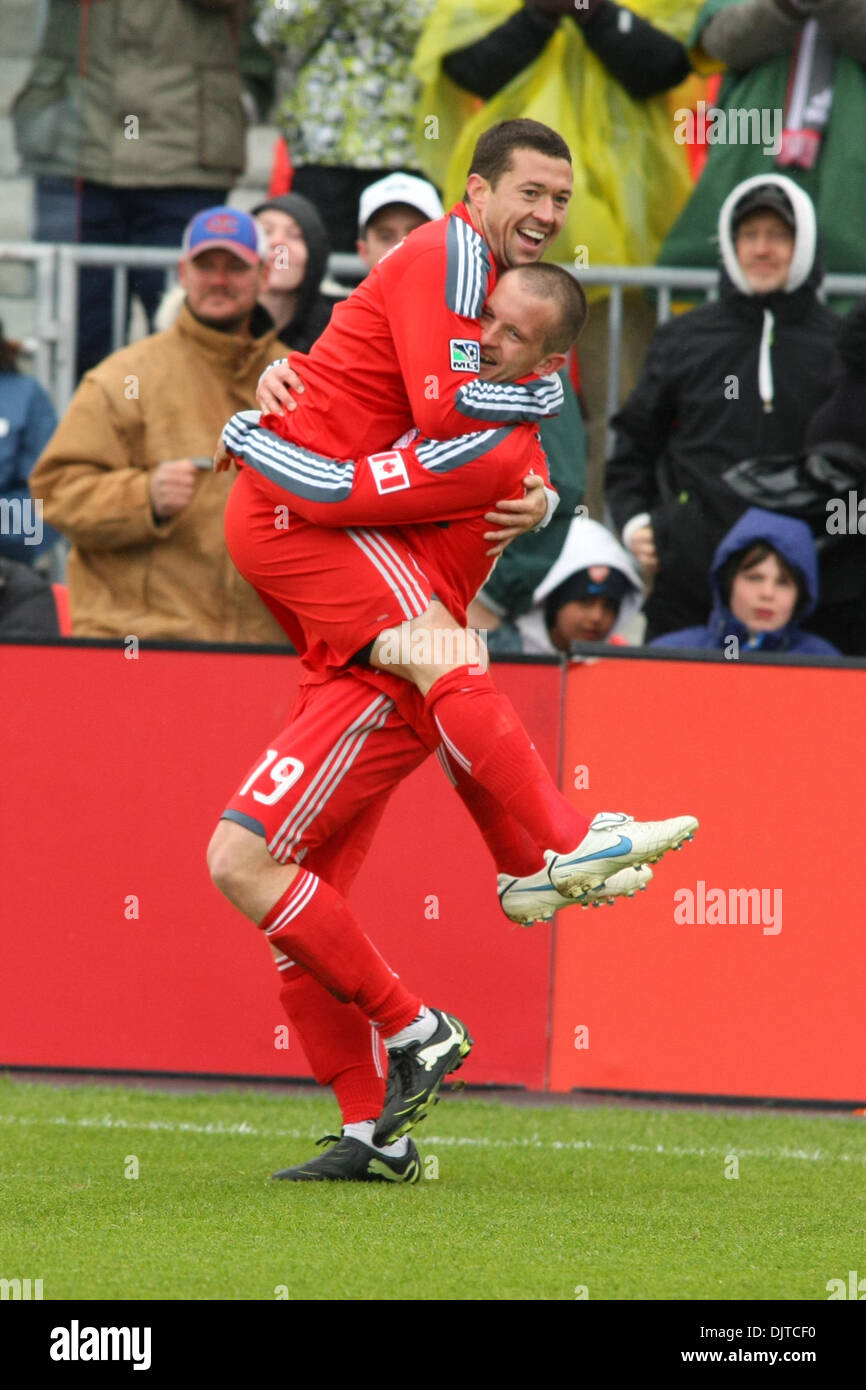 Toronto FC forward Chad Barrett (19) is congratulated after scoring in ...
