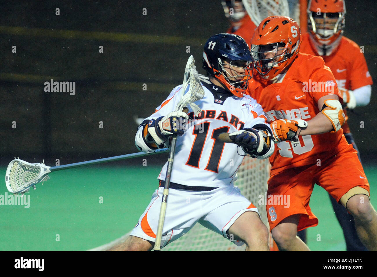Hobart attackman Kevin Curtin (11) gets the stick of Syracuse ...