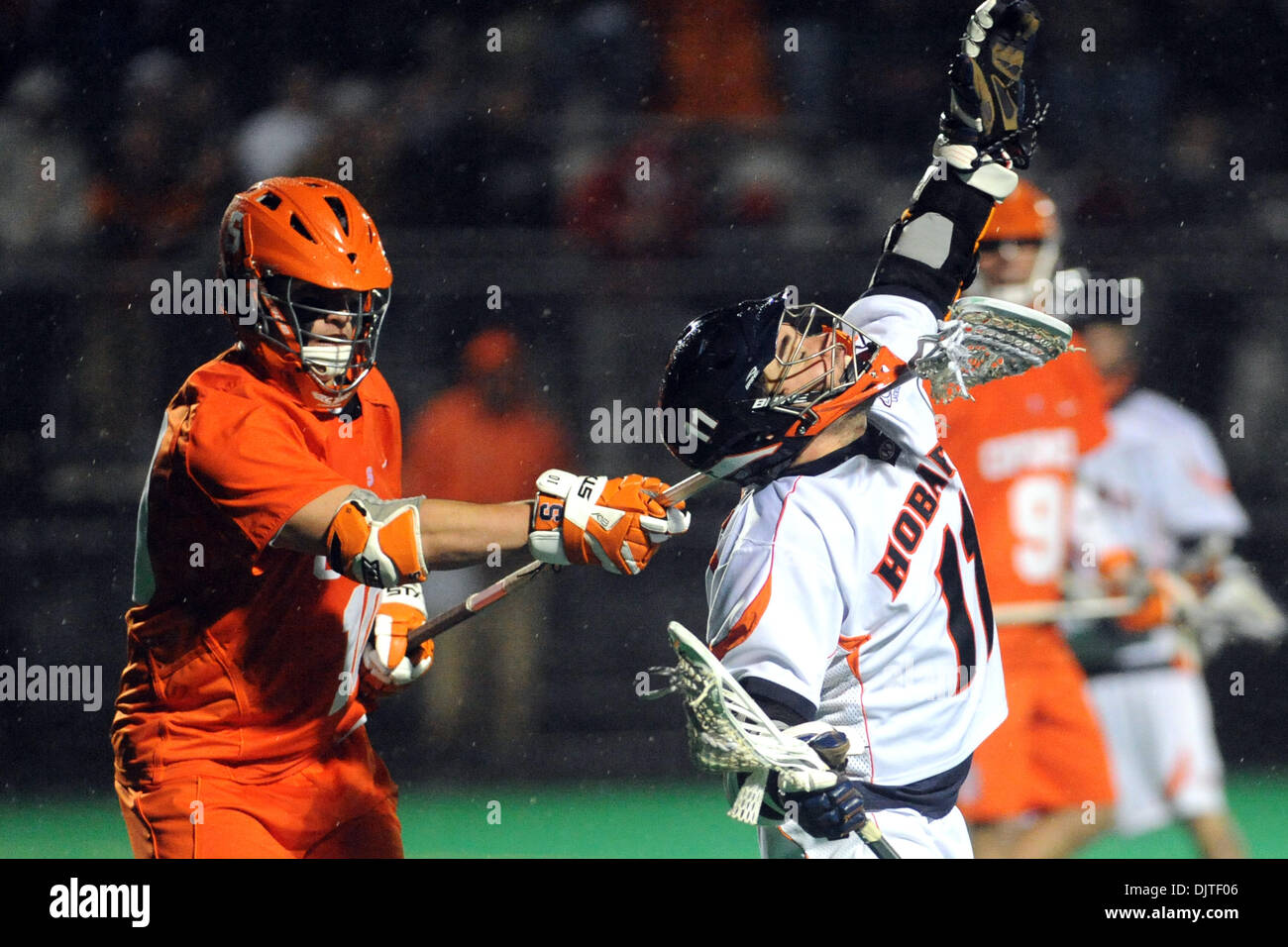 Hobart attackman Kevin Curtin (11) takes the stick to the head in the ...