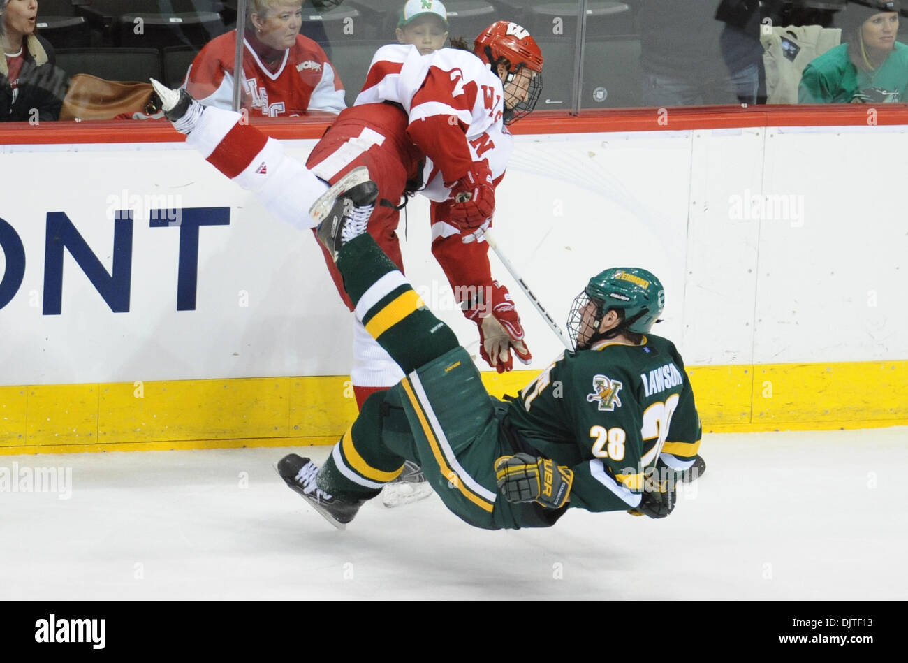 Blake Geoffrion #5 of the Wisconsin Badgers checks Dan Lawson #28 of ...