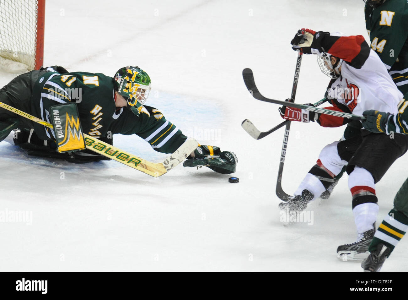 Brian Stewart of the Northern Michigan Wildcats stretches to cover a ...