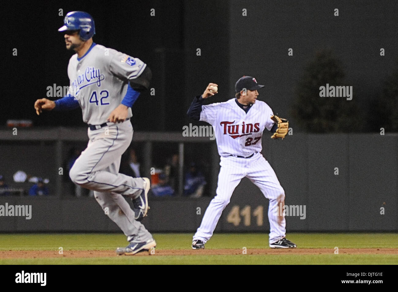 Minnesota Twins shortstop J.J. Hardy #27 fields the ball throwing to ...