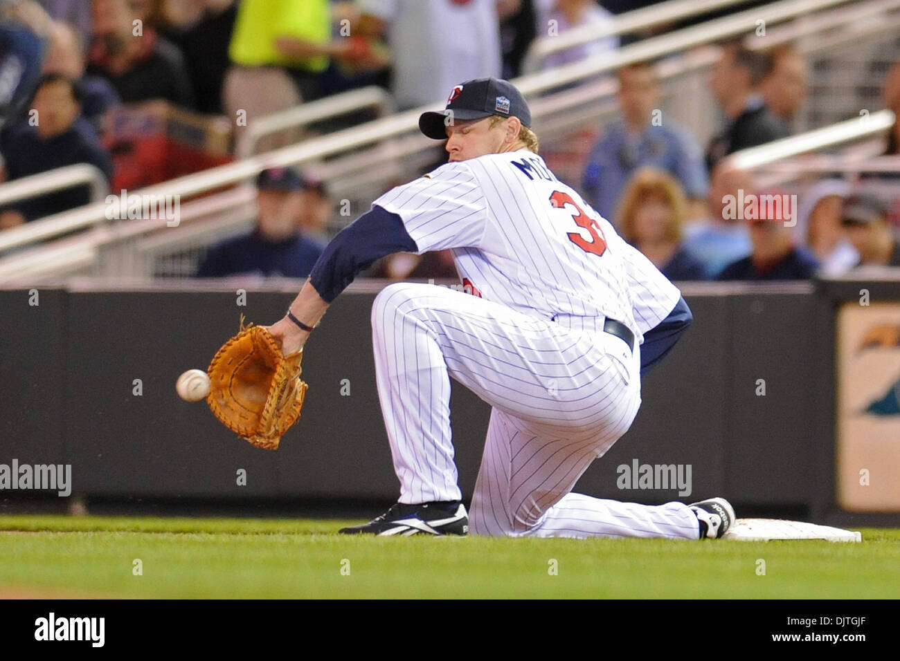 Minnesota Twins first baseman Justin Morneau #33 scoops up a throw from ...