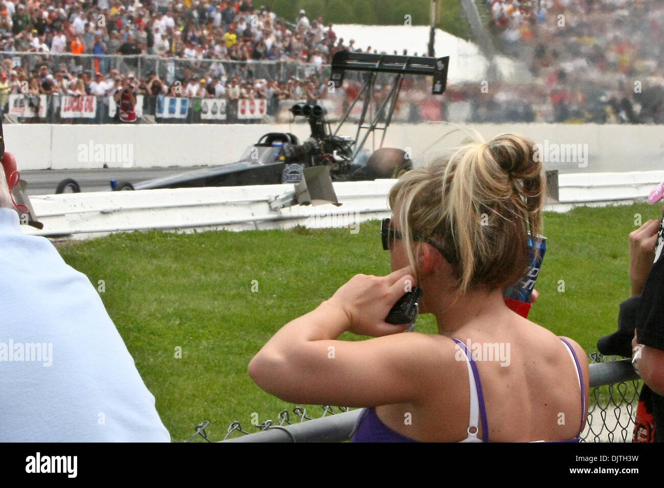 2 May 2010: A fan plugs her ears as a Top Fuel Dragster passes during ...