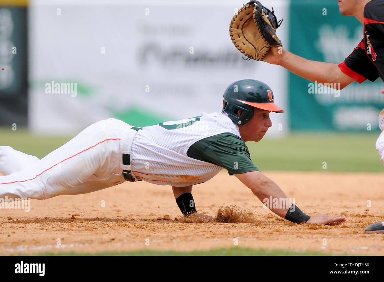 Miami Hurricanes OF Nathan Melendres (10) dives back to first base. The ...