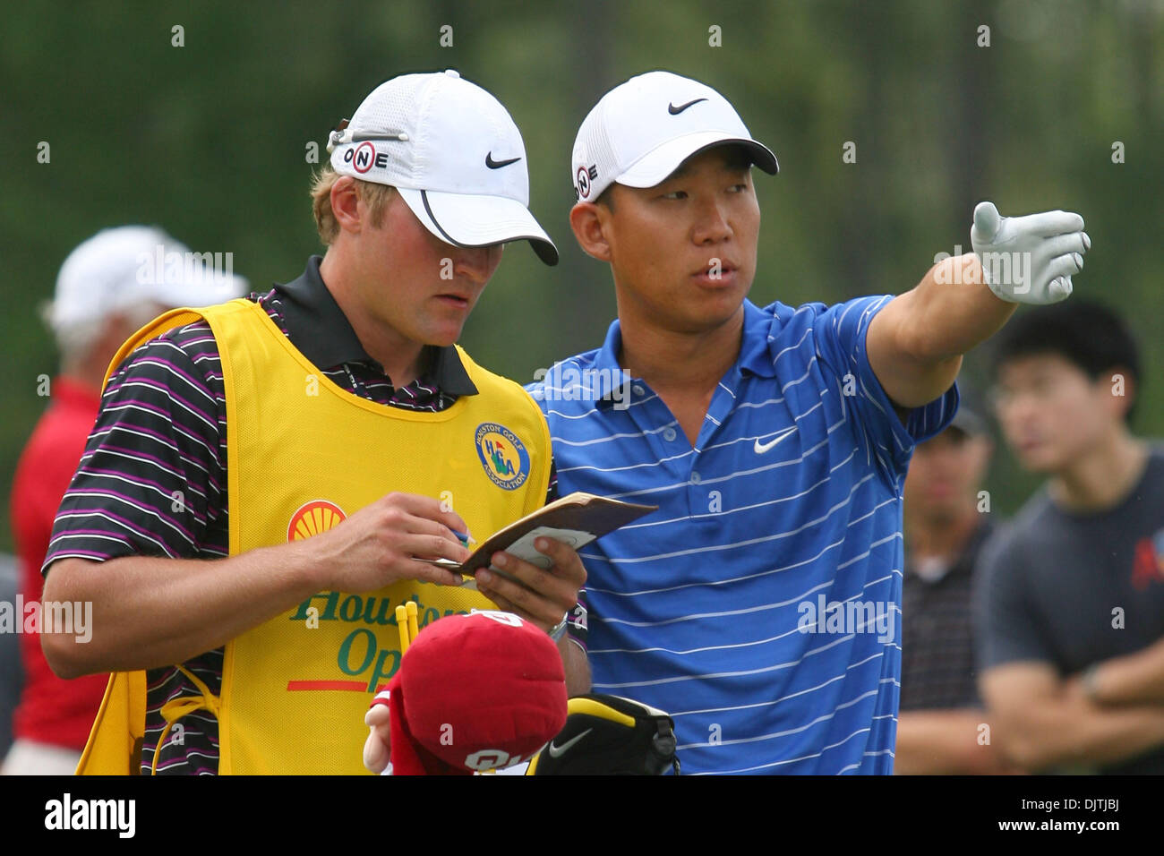 Anthony Kim discusses his strategy with his caddie Brodie Flanders at ...