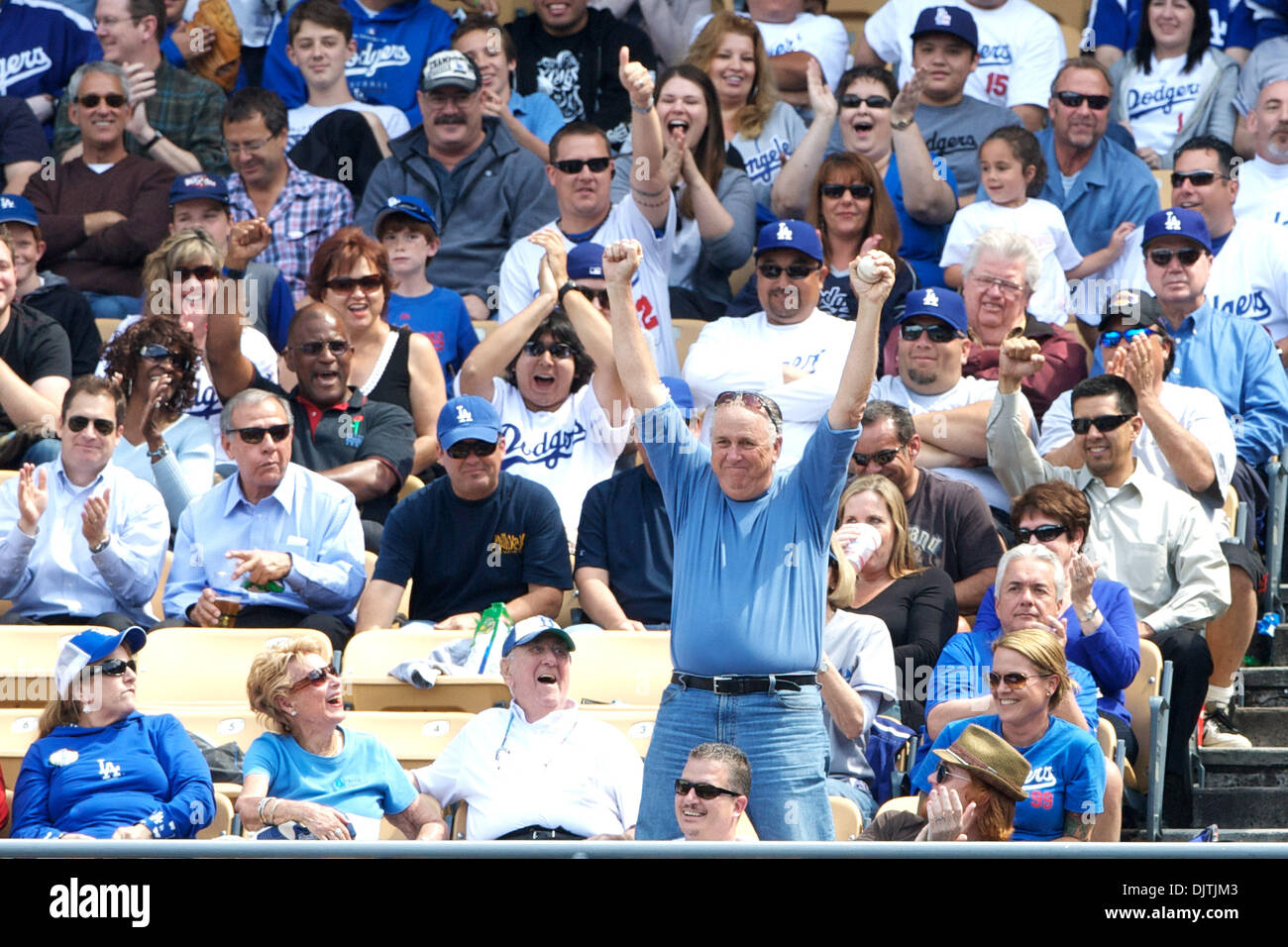 A Dodger fan reacts to catching a foul ball hit by Manny Ramirez during ...