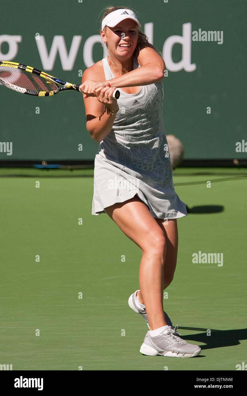 Caroline WOZNIACKI (DEN) returns a shot against Nadia PETROVA at the ...