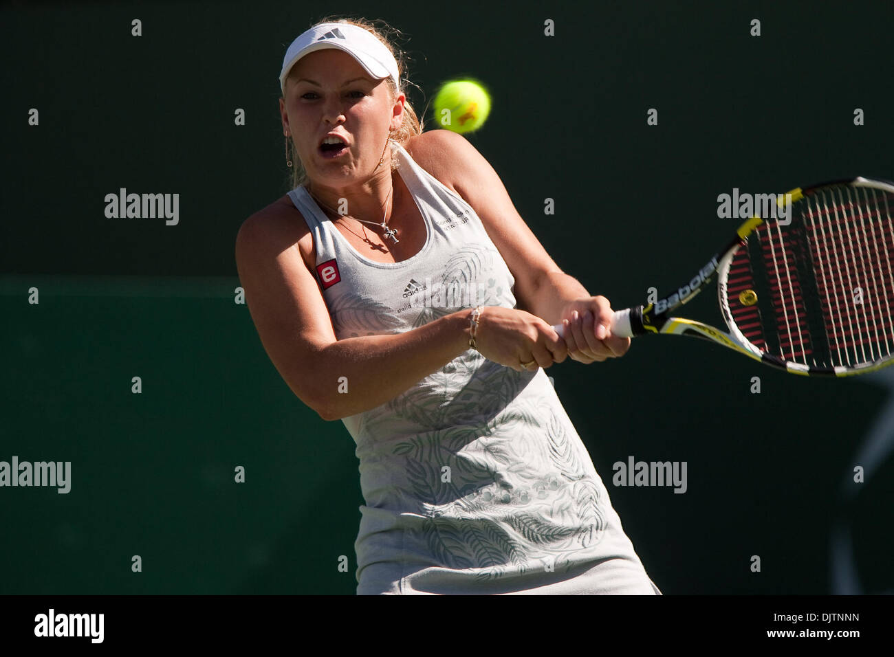 Caroline WOZNIACKI (DEN) returns a shot against Nadia PETROVA at the ...