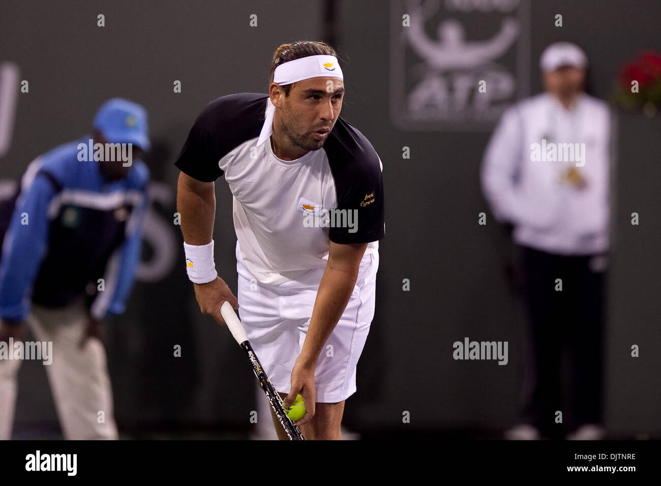 Marcos BAGHDATIS (CYP) prepares to serve against Roger FEDERER (SUI) at ...