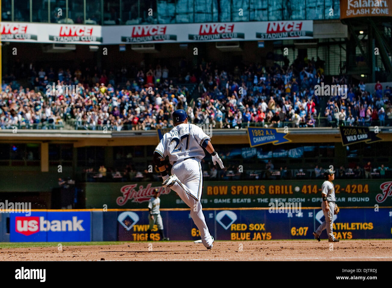 Milwaukee Brewers center fielder Carlos Gomez #27 rounds first base on ...