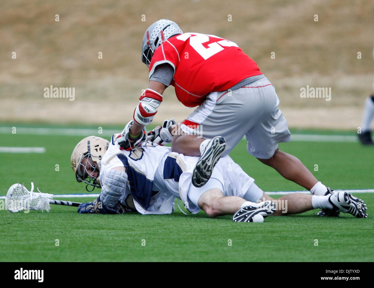 Ohio State Midfielder Dominique Alexander (25) holds down Notre Dame ...