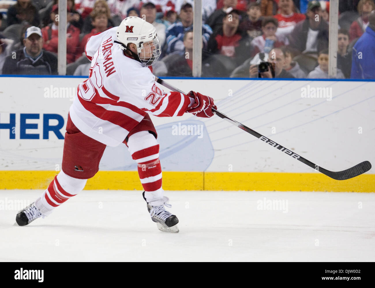 Miami Defenseman Joe Hartman (#26) follows through on pass in game ...