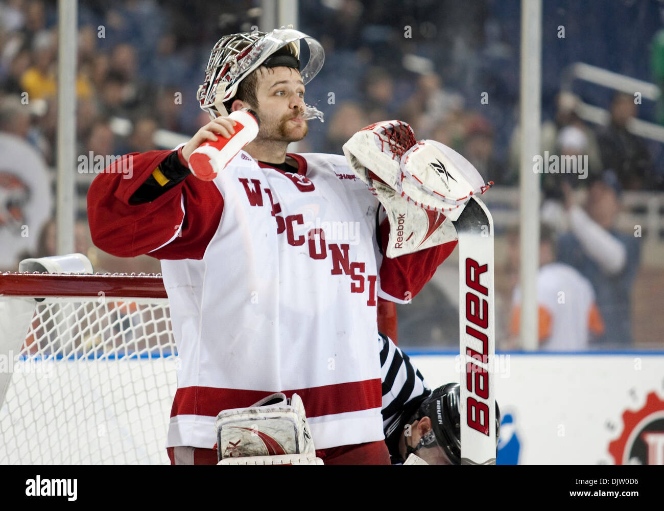 Wisconsin Goaltender Scott Gudmandson (#1) takes a water break during ...