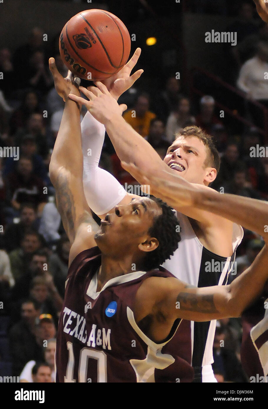 Purdue's guard Chris Kramer, right, is fouled on his way to the basket ...