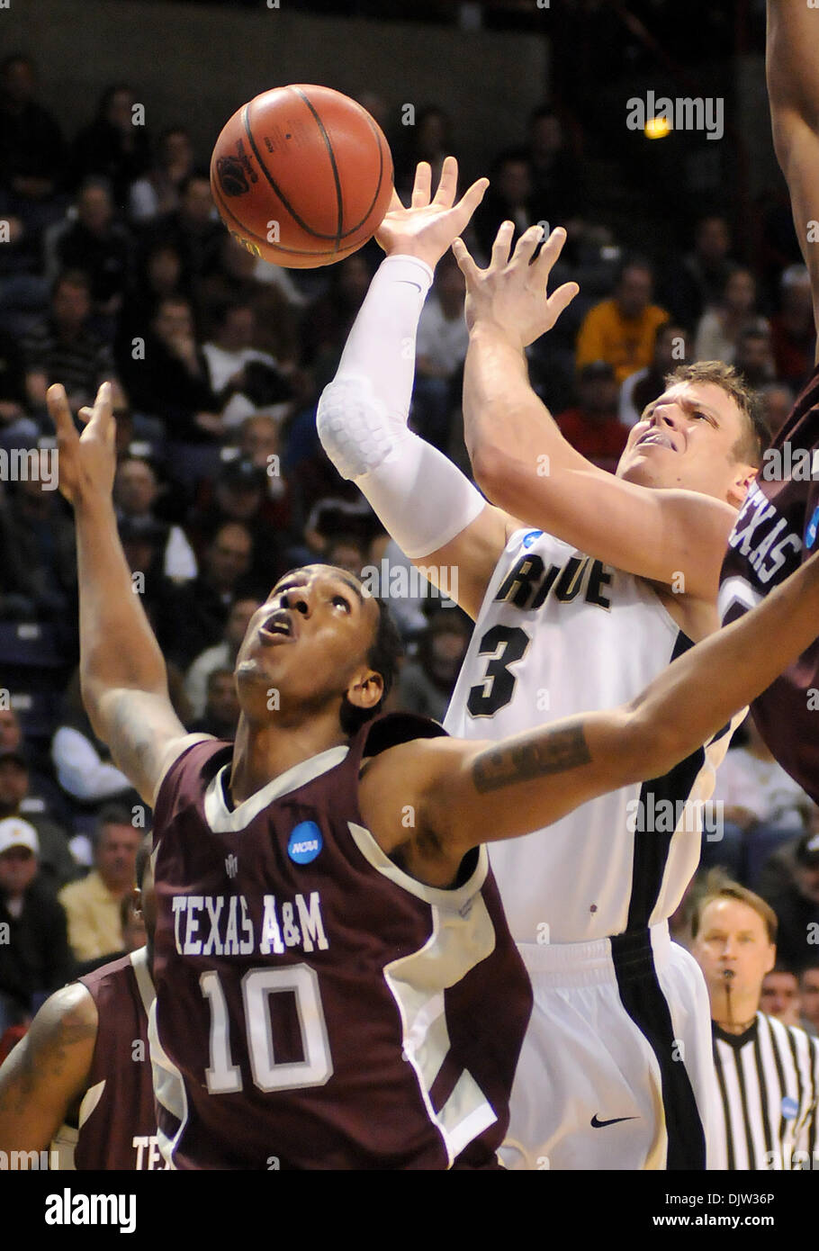 Purdue's guard Chris Kramer, right, is fouled on his way to the basket ...