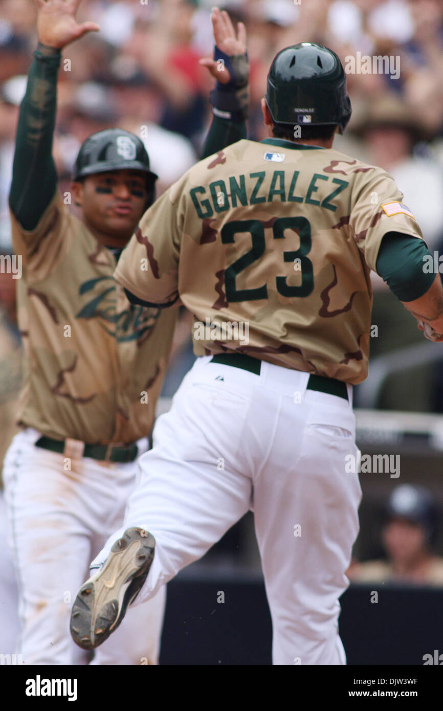 San Diego Padres Adrian Gonzalez scores on a Chase Headley double ...
