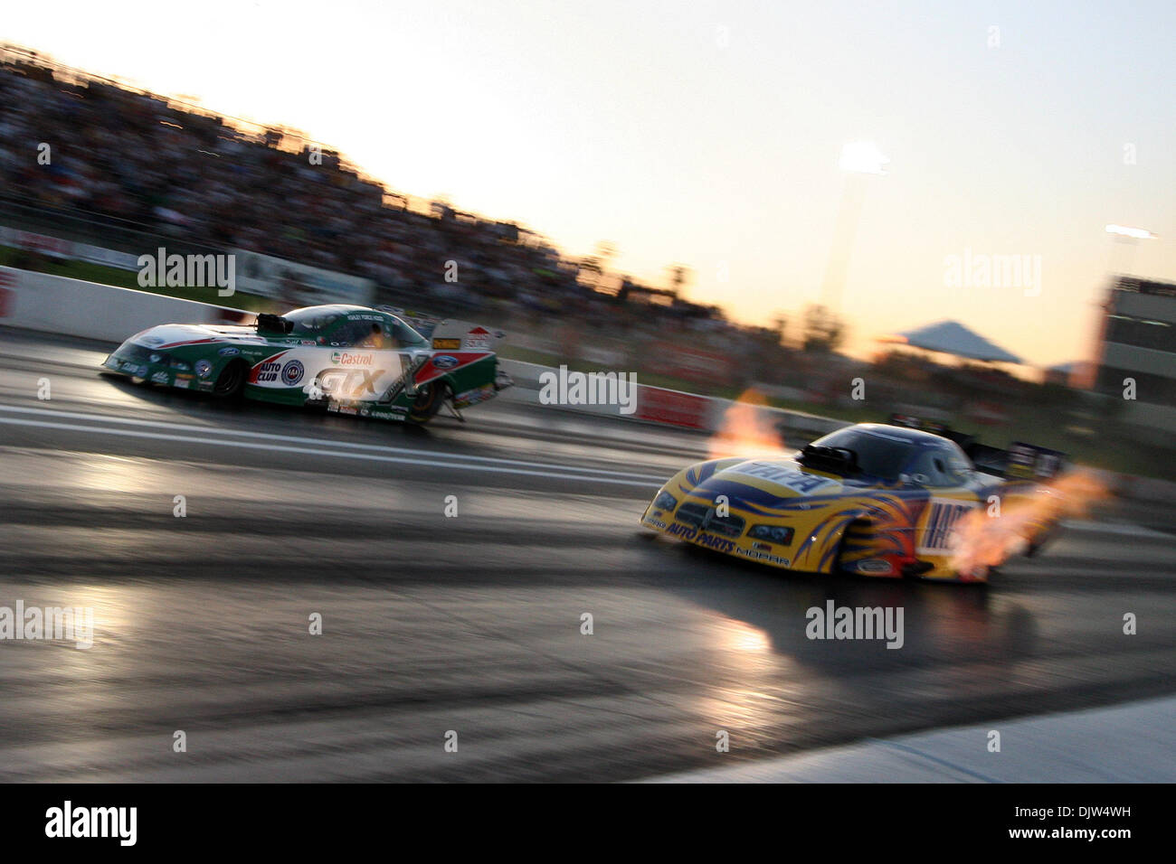 Ashley Force Hood races Ron Capps during the first day of competition ...