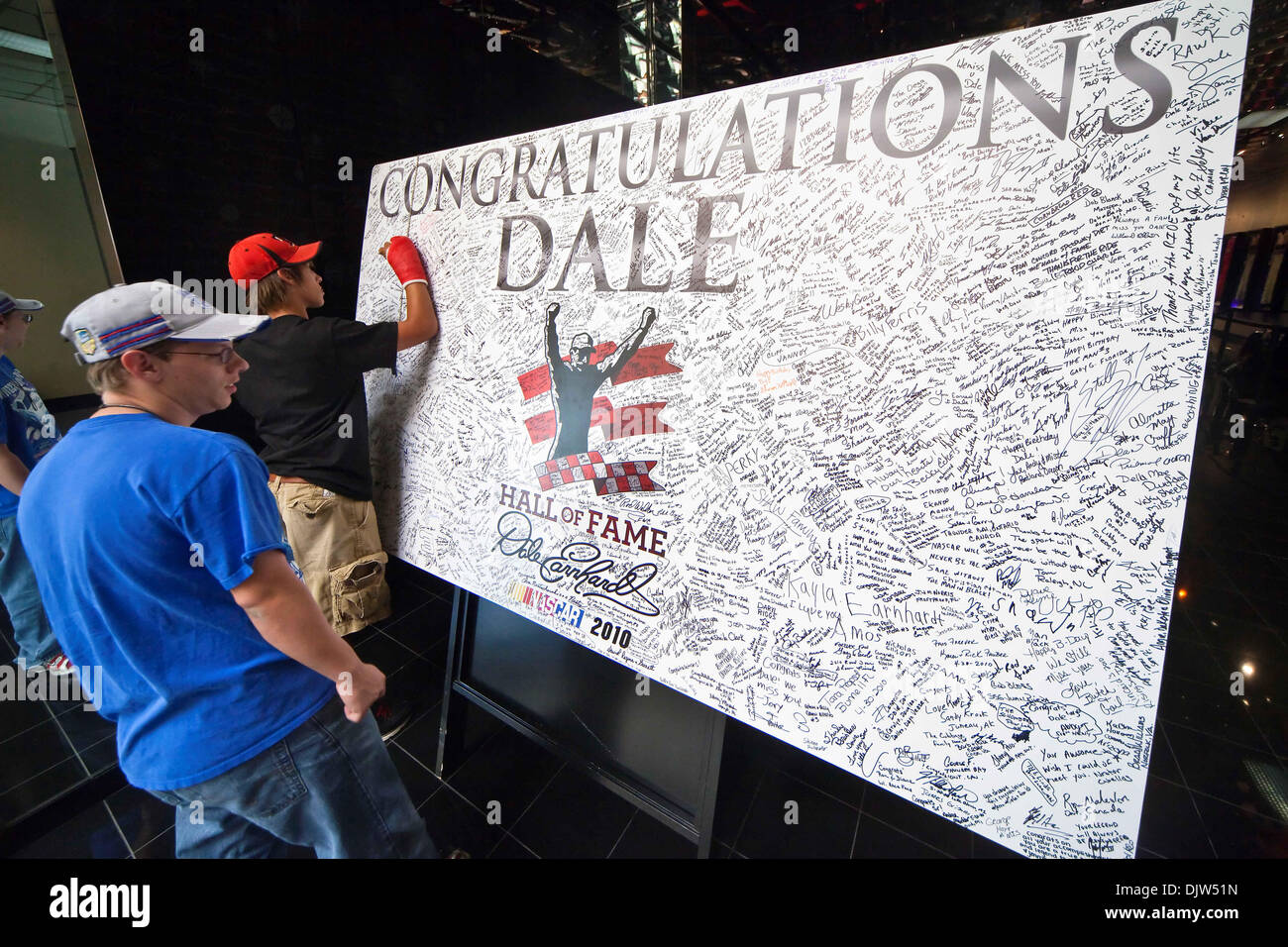 Fans sign a congratulations card for Dale Earnhardt in the front of DEI ...