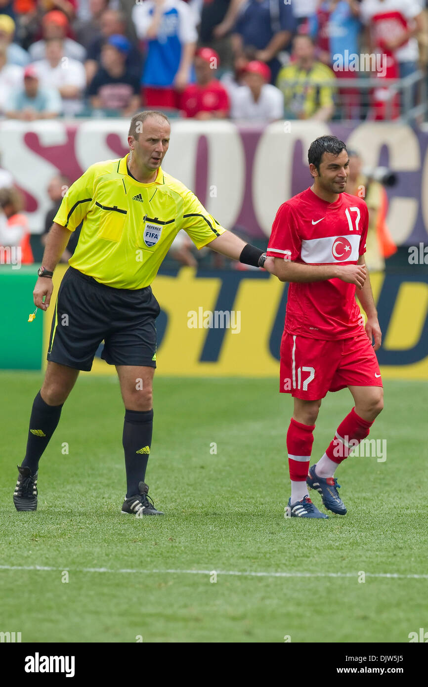 Referee Silviu Petrescu (Canada) gives Turkey mid-fielder Selcuk Inan ...