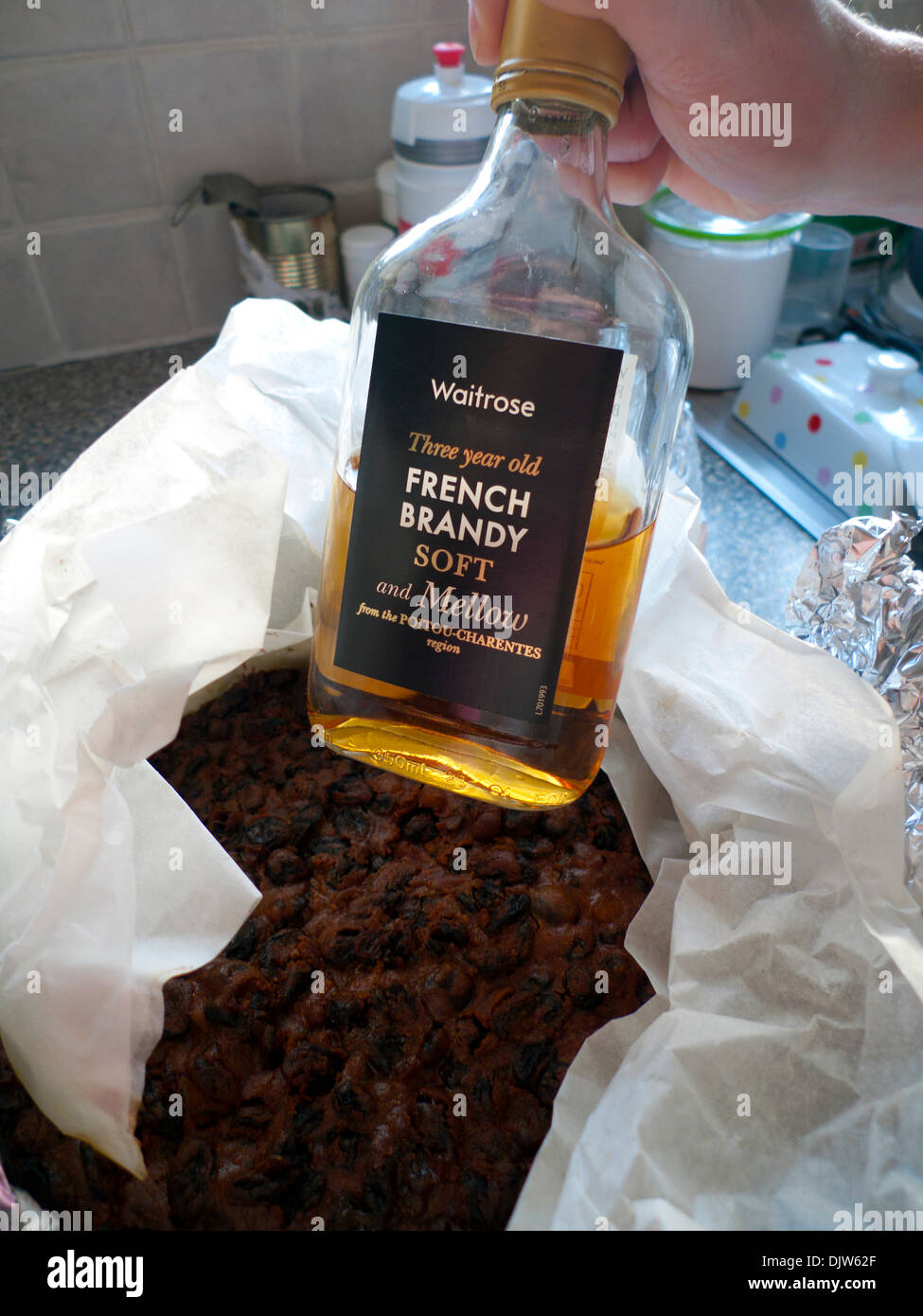 Close up of brandy being poured on a Christmas cake London England UK ...
