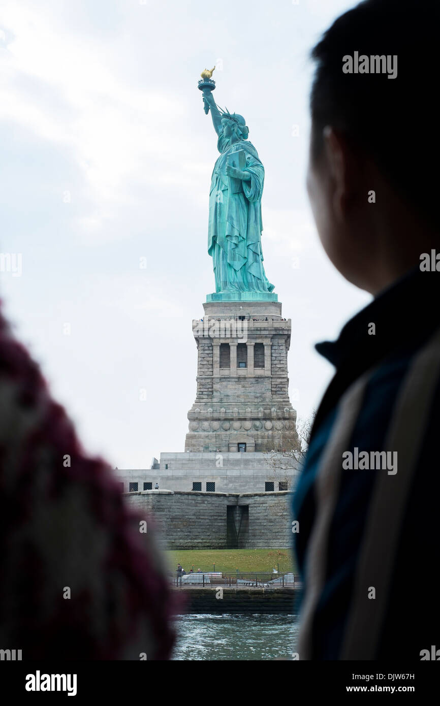 Tourist looking at the statue of liberty hi-res stock photography and ...