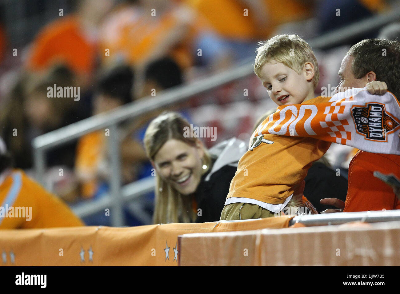 A young Houston Dynamo fan holds a scarf in support of the team. With ...