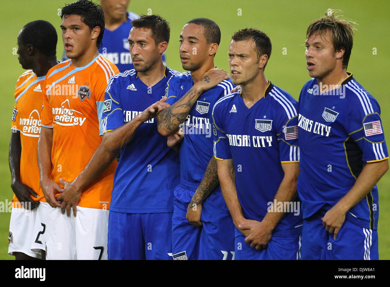 Houston Dynamo players stand alongside a wall of Kansas City Wizards in ...