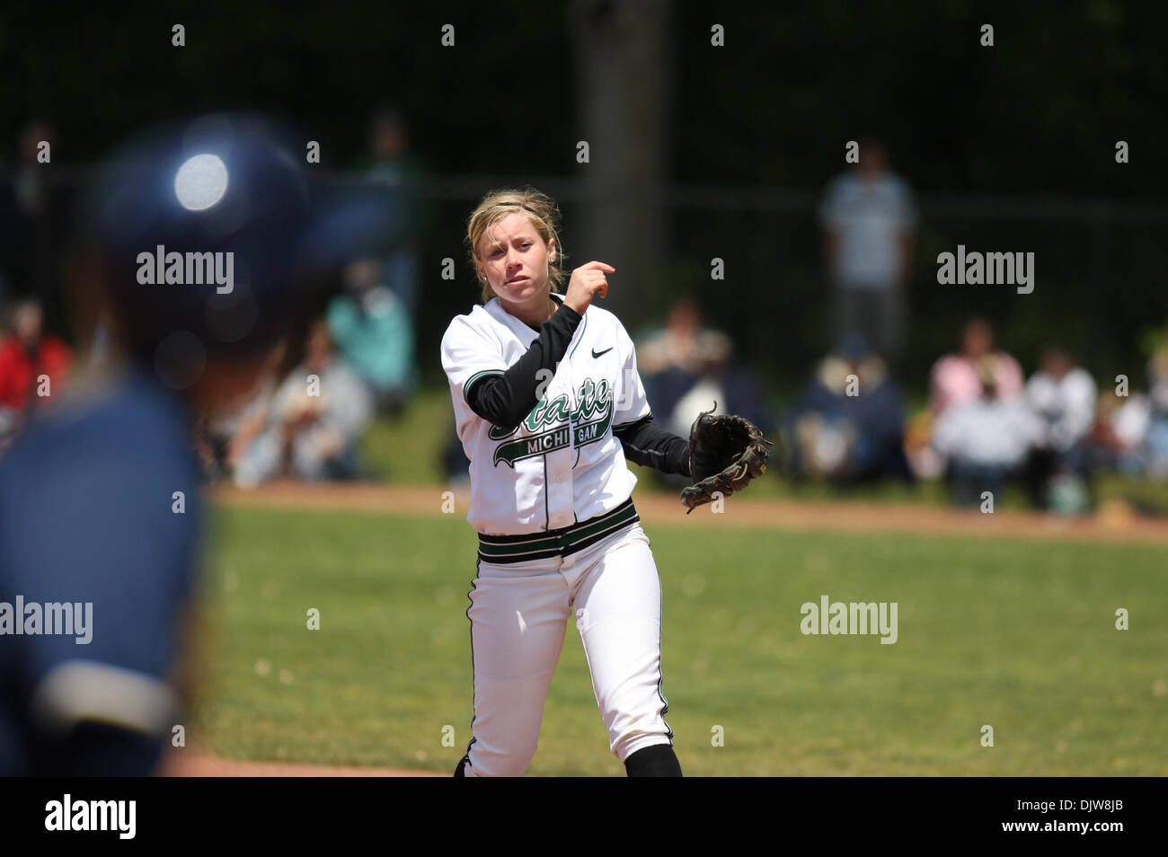 Michigan State 2nd baseman Jenny Ramsaier (1) throws to first base ...