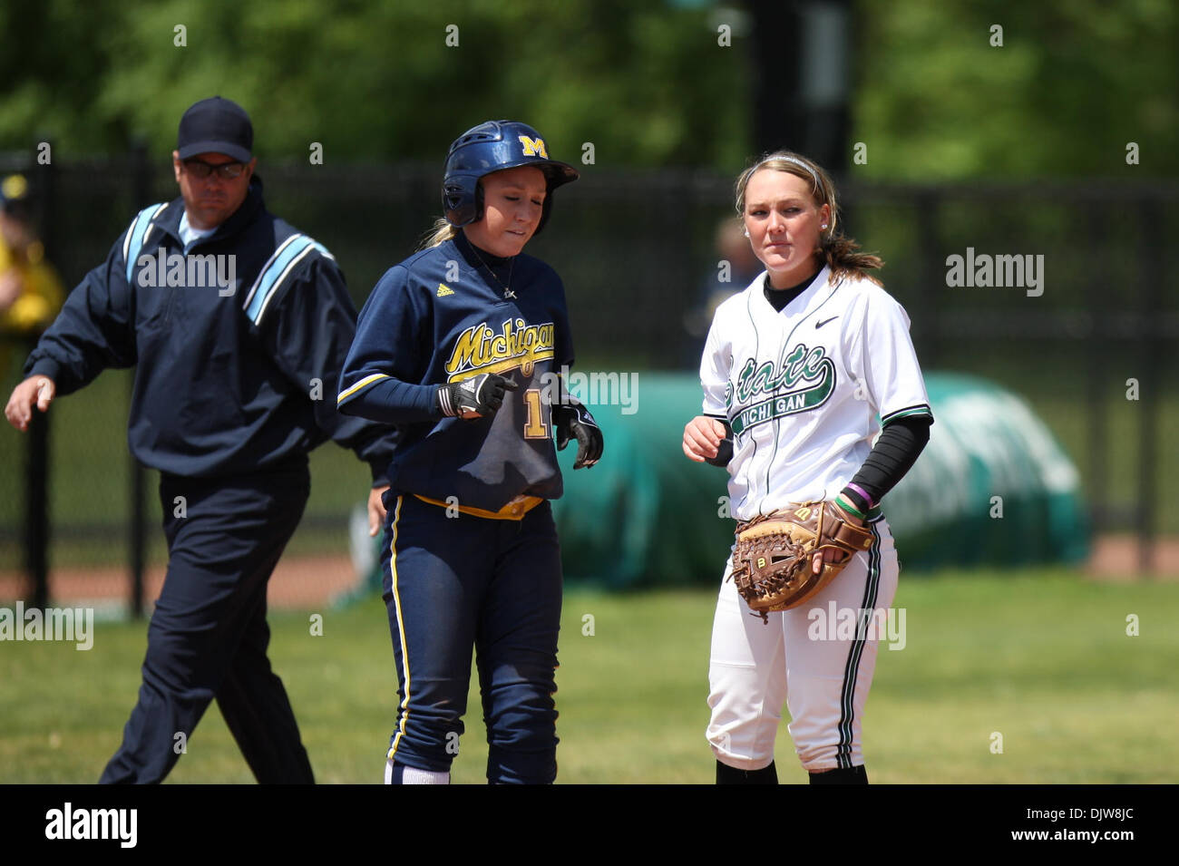 Stephanie Kirkpatrick (12) reaches third base while being watched by ...