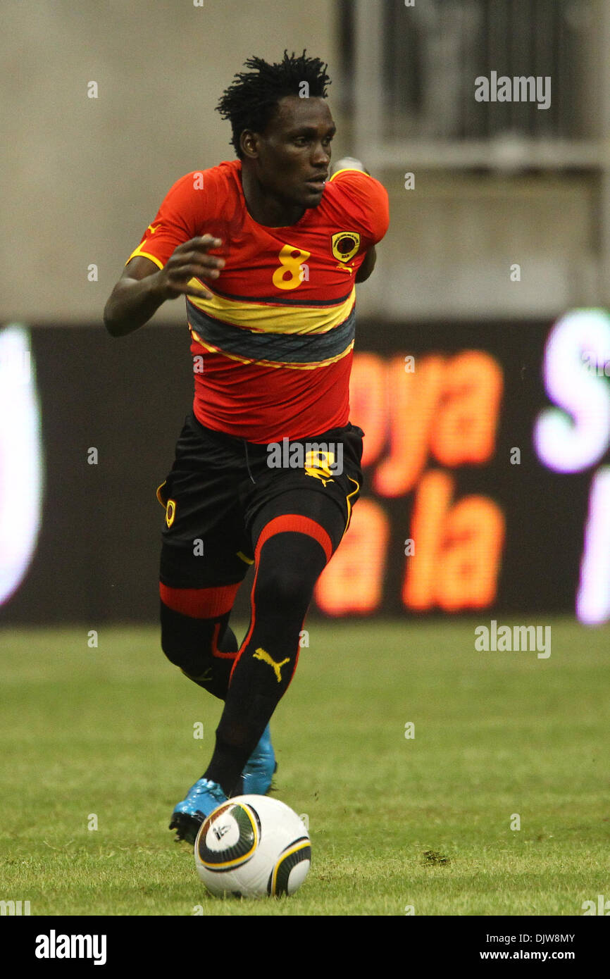 Chara (#8) Midfielder for Angola dribbles the ball at alone at midfield ...
