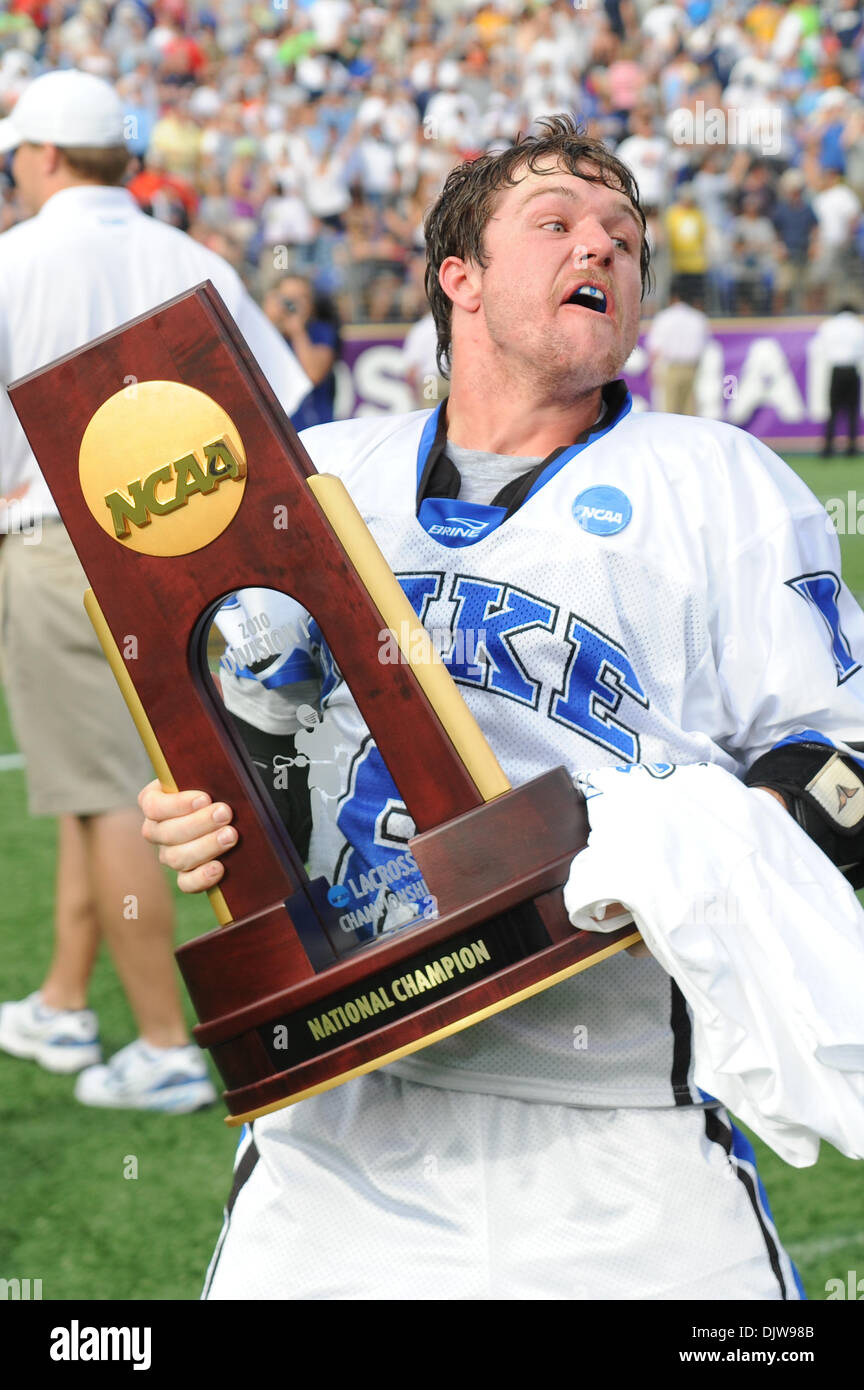 31 May 2010: Duke's Max Quinzani (8) carries the championship trophy ...