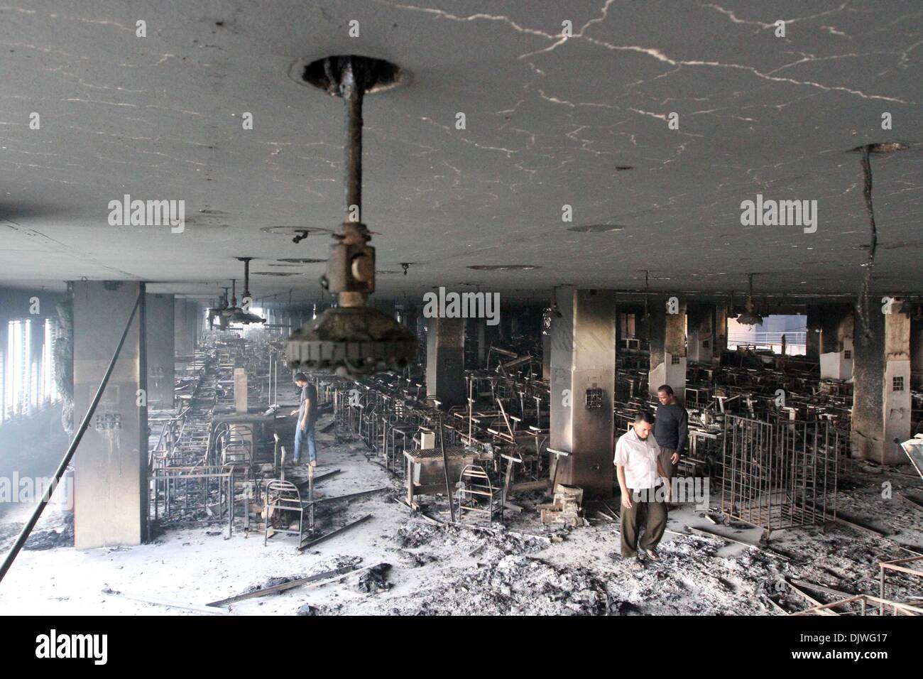 Burnt garments are seen after a fire 10-storey garment building complex ...
