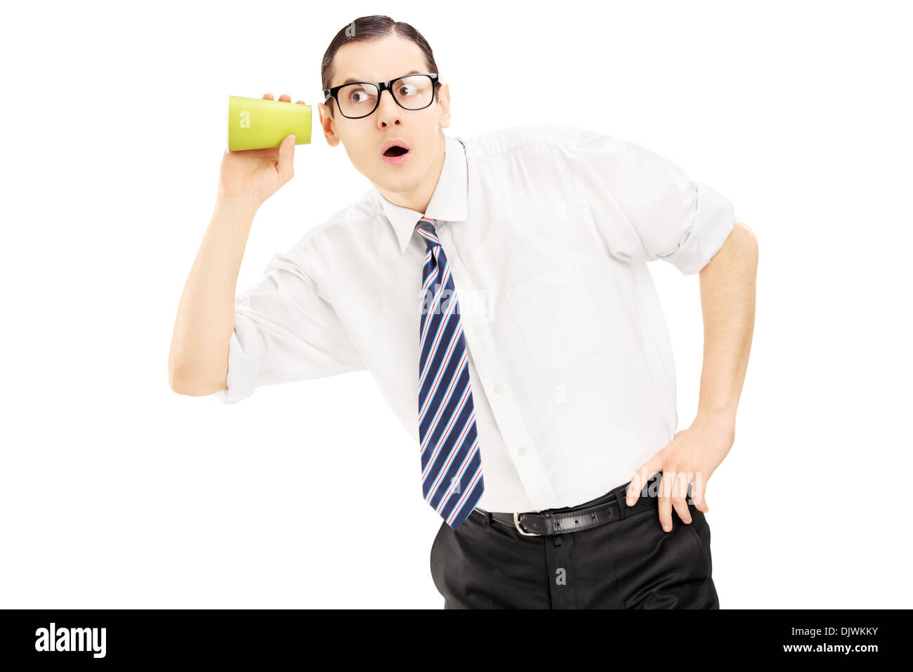 Young man listening through the wall with a cup Stock Photo - Alamy
