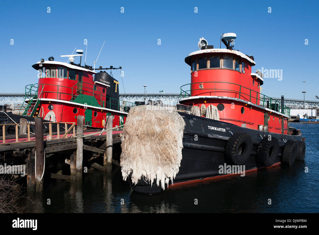 Tug boats in a familiar and traditional red livery on the dock in New ...