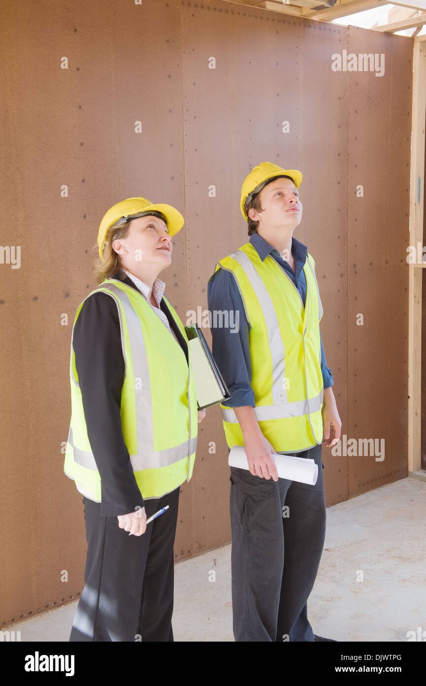 civil engineer and worker discussing issues at the construction site ...