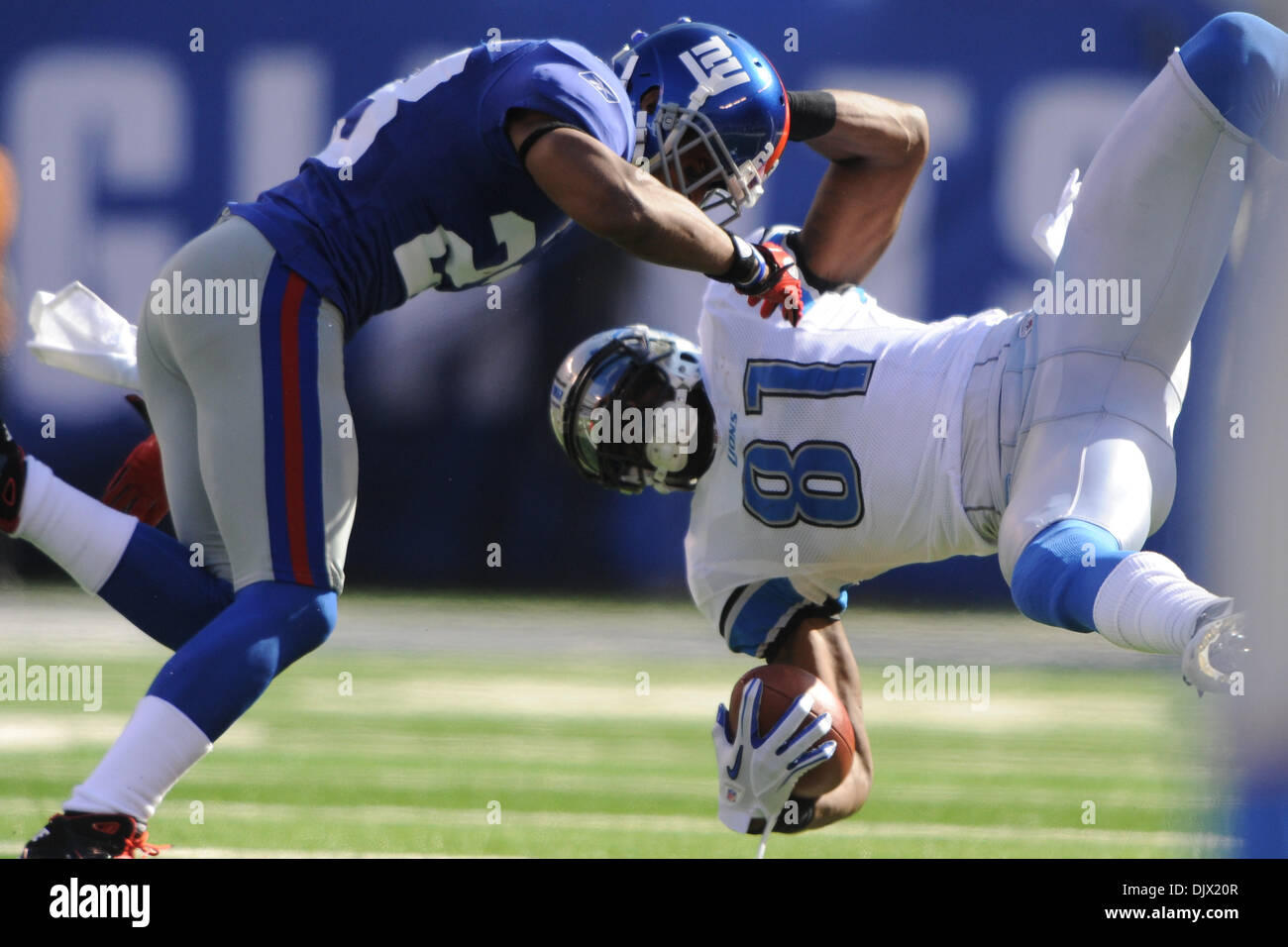 New York Giants cornerback Corey Webster (23) upends Detroit Lions wide ...
