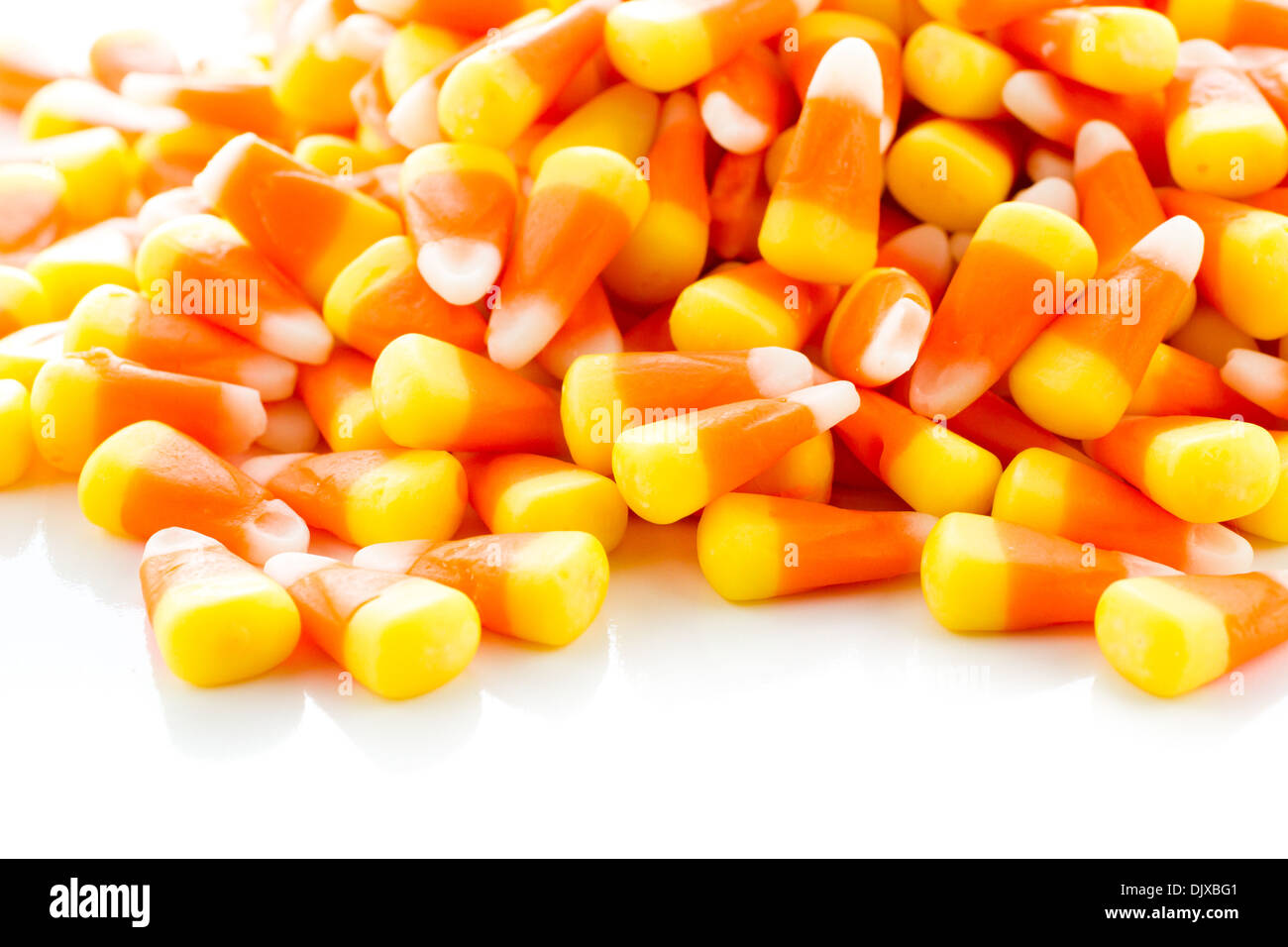 Halloween candy-corn on a white background Stock Photo - Alamy