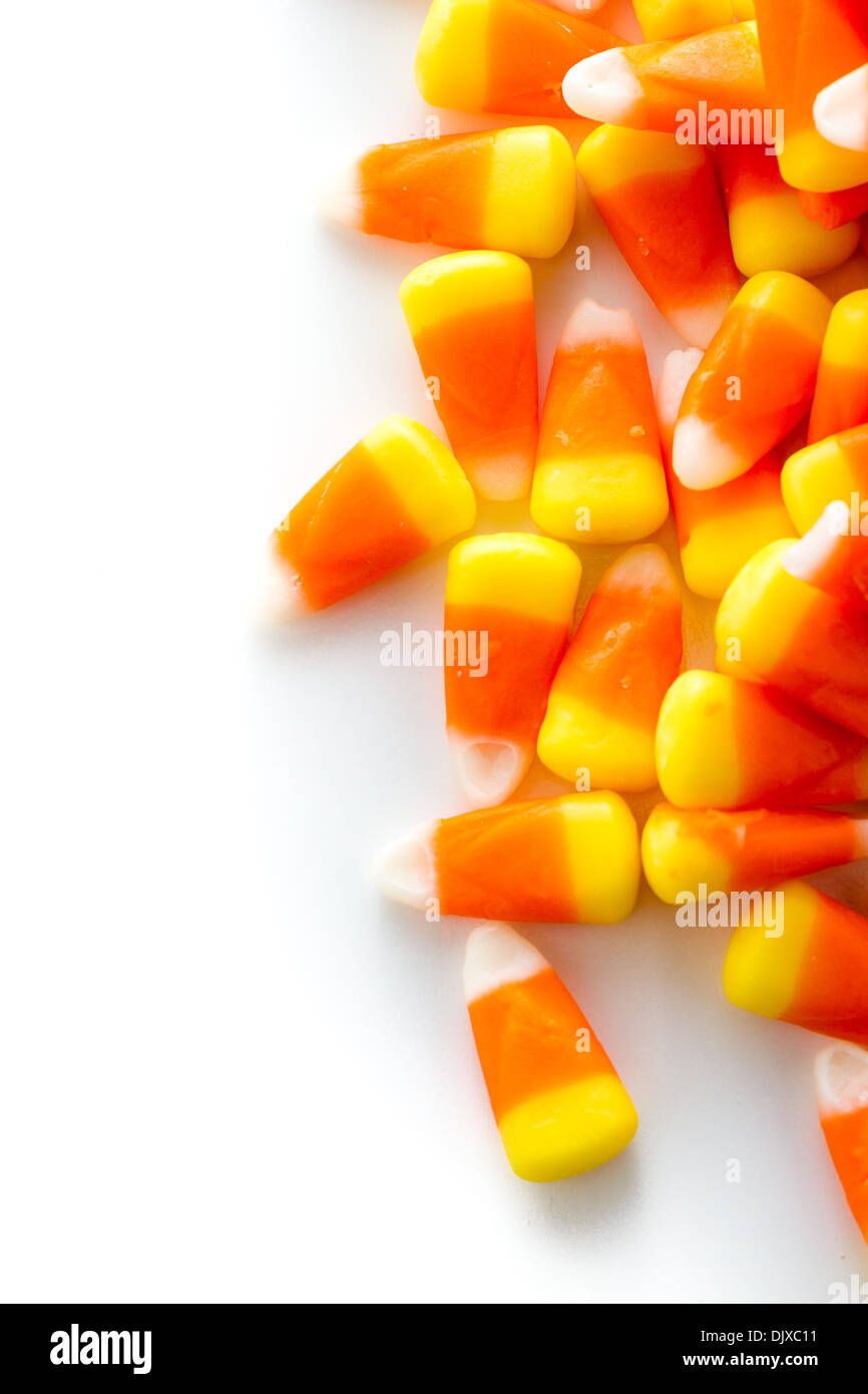 Halloween candy-corn on a white background Stock Photo - Alamy