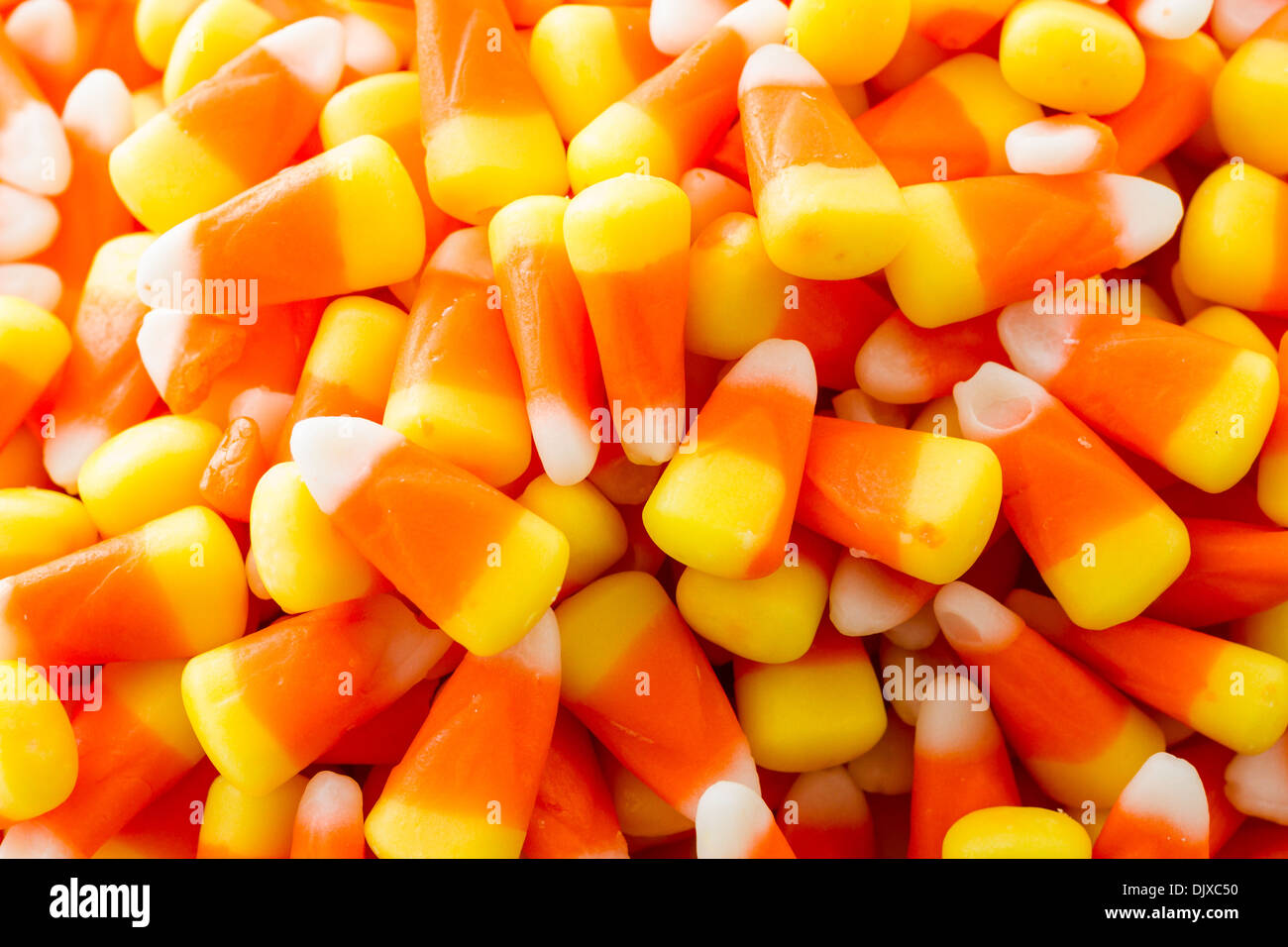 Halloween candy-corn on a white background Stock Photo - Alamy