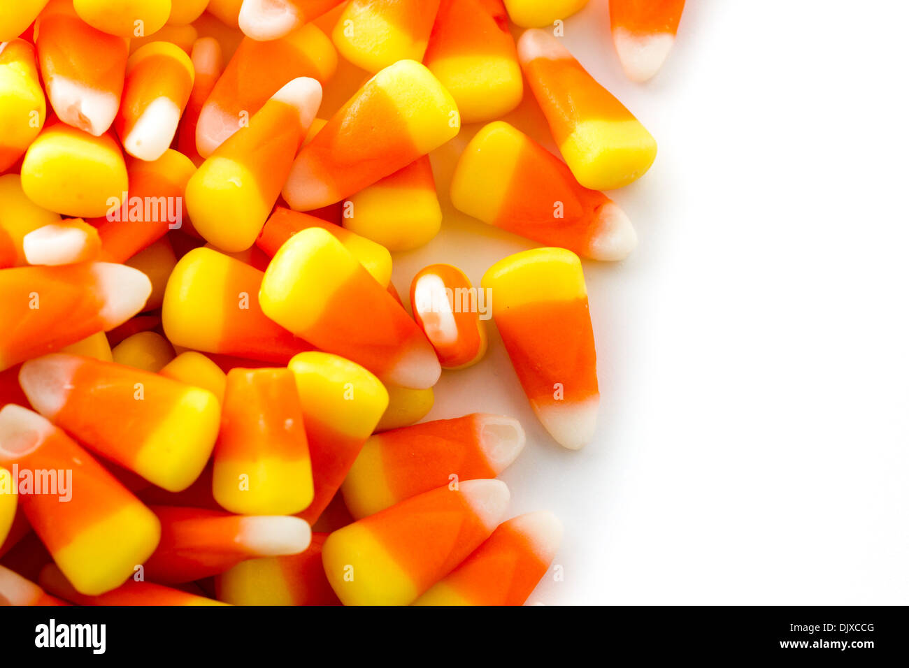 Halloween candy-corn on a white background Stock Photo - Alamy