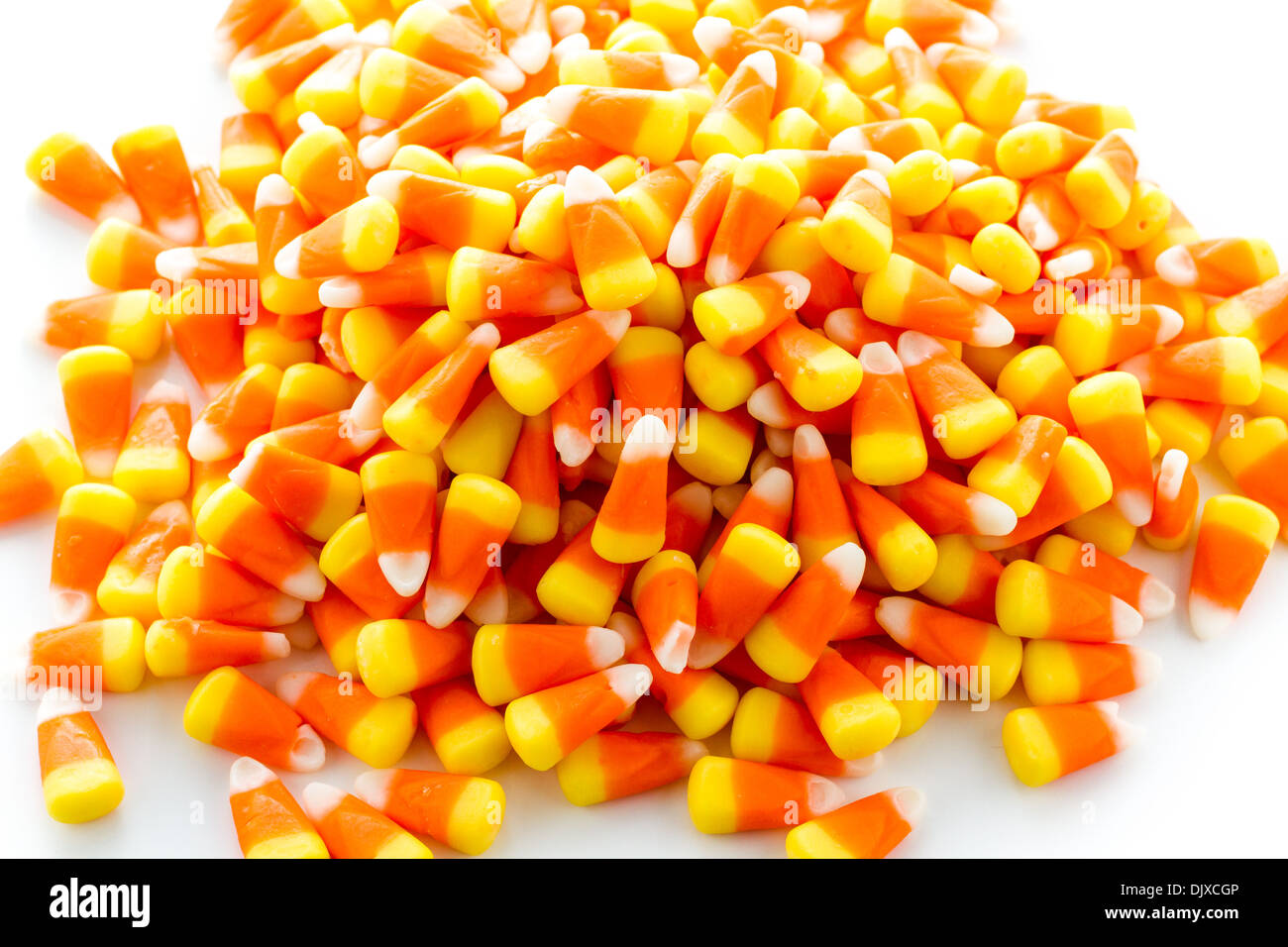 Halloween candy-corn on a white background Stock Photo - Alamy
