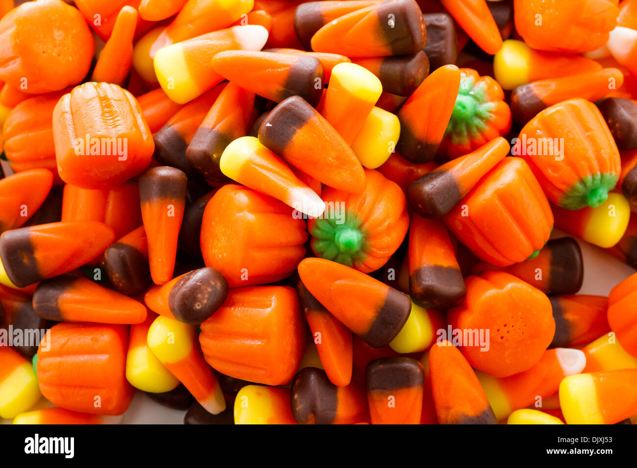 Halloween candy-corn and pumpkins in a pile Stock Photo - Alamy