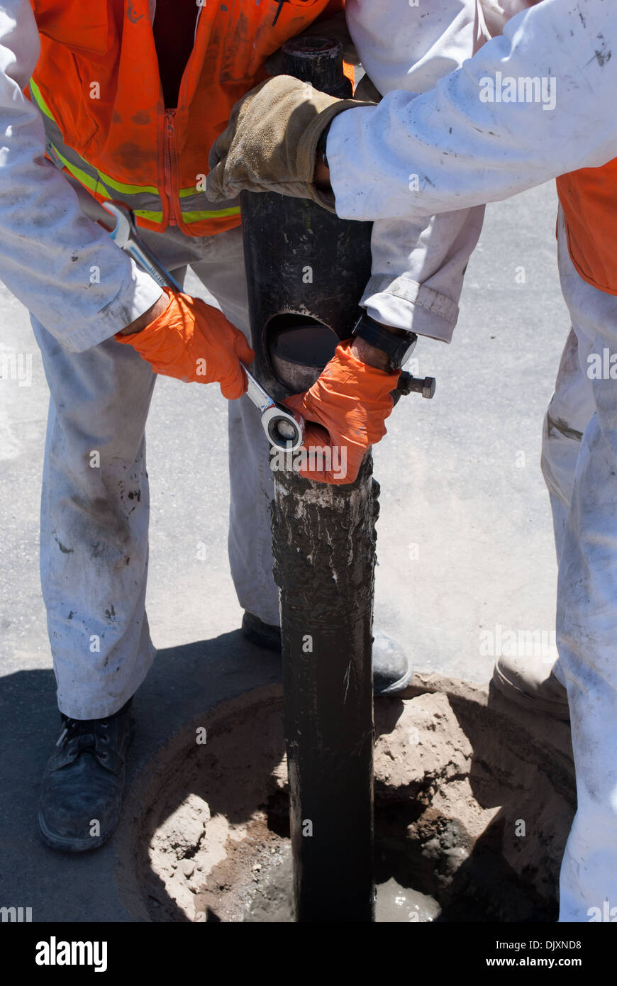 Two Workers and a Well Stock Photo - Alamy