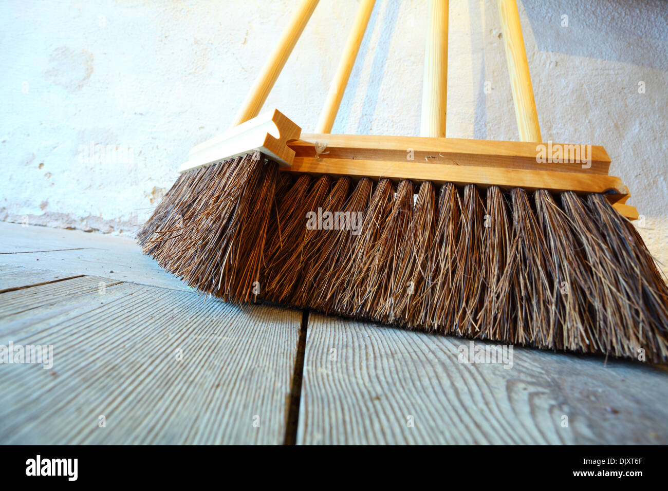 Close up large brooms for house work on old wooden floor of country ...