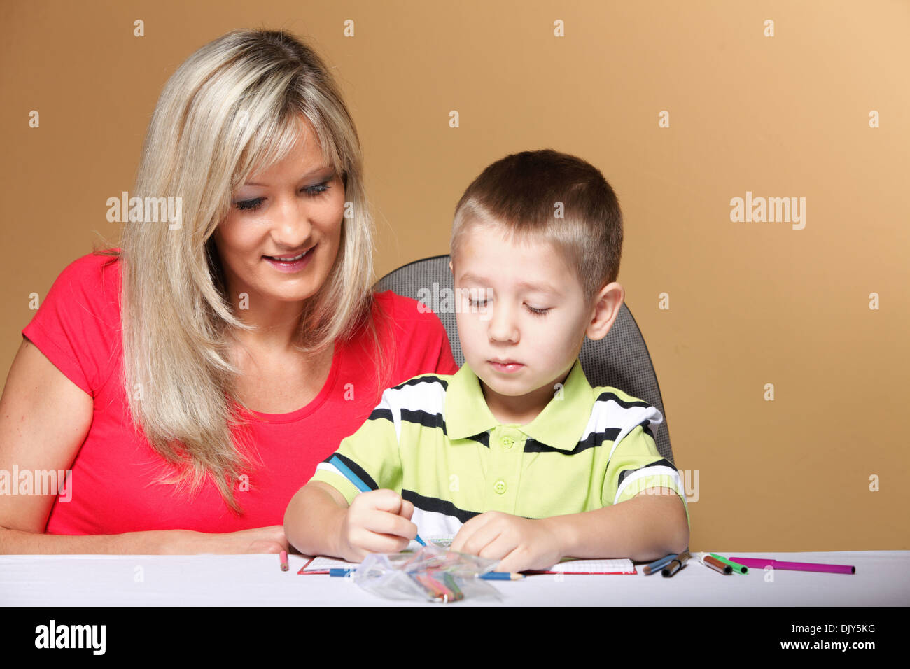 mother and son drawing together, mom helping with homework daycare ...
